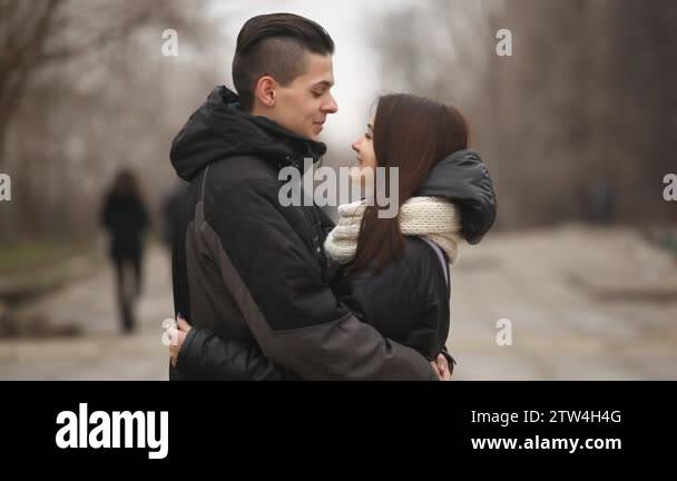 Young couple stand and hug each other happily on an arty alley in ...