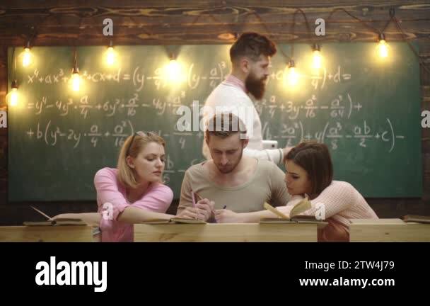 Group of students studying together in a classroom, group of four young ...