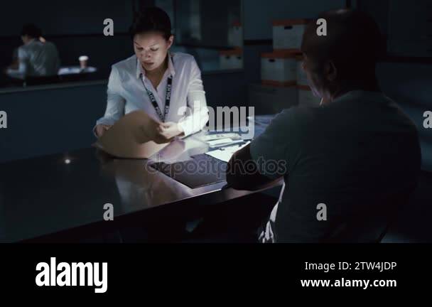 4K Female police detective questioning a crime suspect in interrogation ...