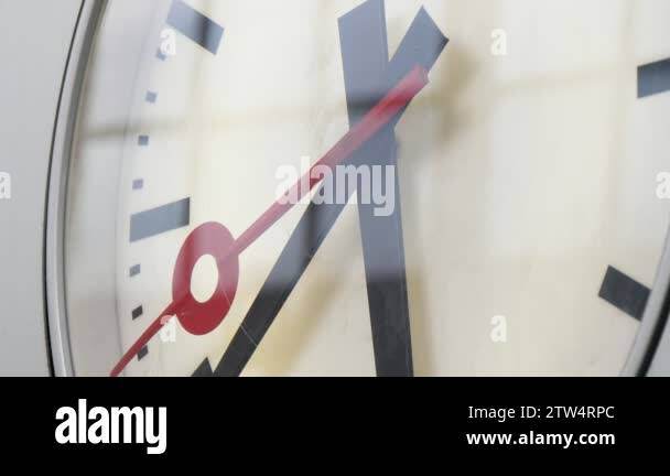 Retro round clock with three arrows in Antwerp terminal placed askew ...