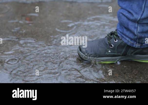 Puddle child shoe Stock Videos & Footage - HD and 4K Video Clips - Alamy