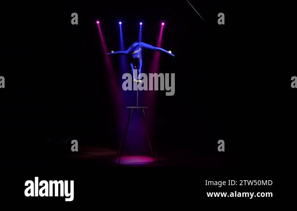 Flexible beautiful slim gymnast artist performing on the stage. 4K ...