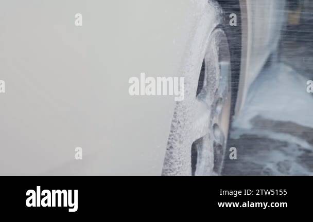 Close up, car washing, detailing. Wheel of car is washing with soap and ...