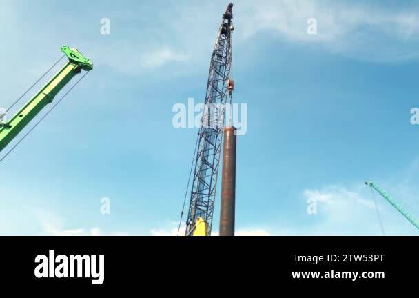 The crane is lifting the casting pipe to press down on the ground to ...