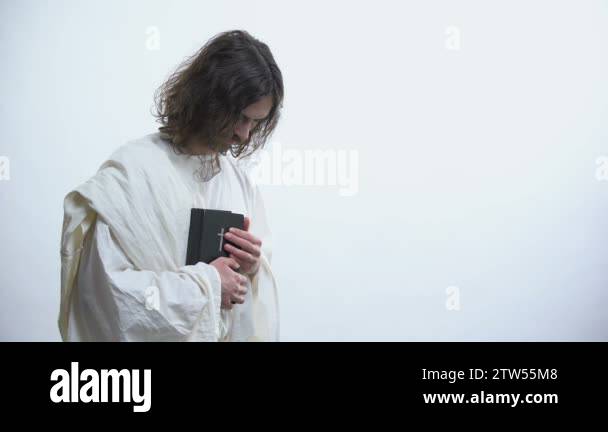 Jesus showing Holy Bible to camera, calling for prayer, Christian ...
