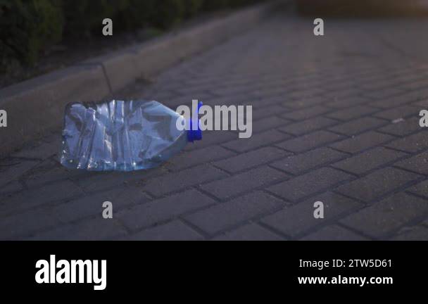 Plastic bottle lying on the ground at night in front of a car - Thrown ...
