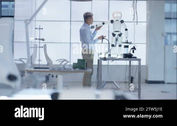 4K Technical engineer working on construction of automated robot in ...