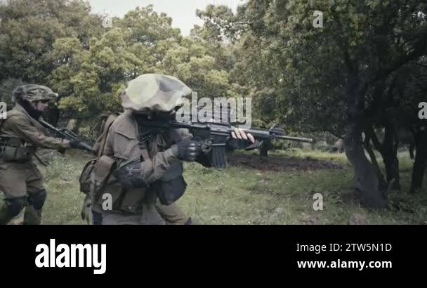 Squad of fully armed commando soldiers during combat in a forest ...