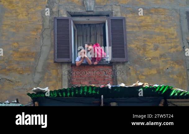 CAIRO, EGYPT - DECEMBER 21, 2017: Two little girls play at the window ...
