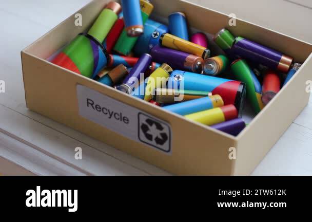 A recycling box for used batteries. The three chasing arrows of the ...