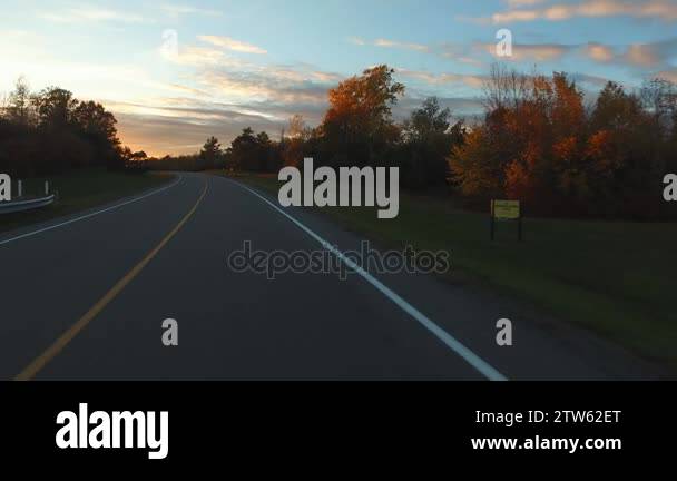 Driving a Car in Point of View Perspective on a Road at Sunset ...