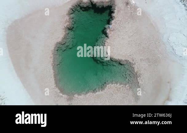 Senital aerial drone scene of blue lagoon at wide white salar ...
