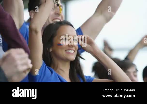 4K Excited fans with US flag in sports crowd cheering on their team ...