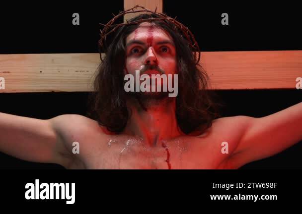 Jesus Christ suffering agony in red lights, blood and tears on body, crucifixion Stock Video ...