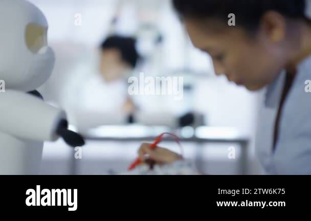 4K Technical design team working on construction of robot in modern lab ...