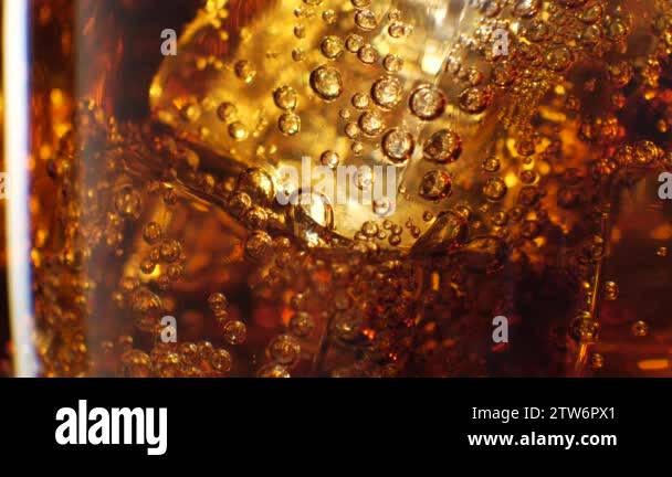 Cola with ice background. Large glass of cold coke with ice cubes close ...