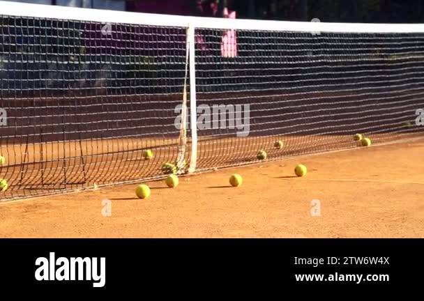 Tennis court before the game.Balls on the tennis court.Balls roll down ...
