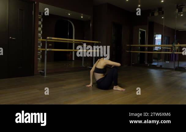 girl dancer with ponytail in black tights demonstrates body flexibility ...