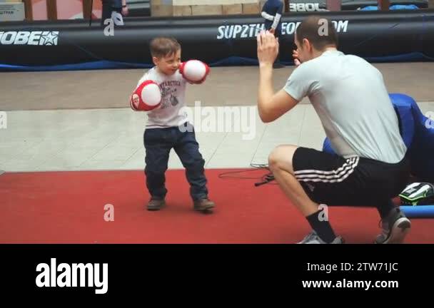 Moscow, Russia - April 12, 2019: Cute boy training with coach and in ...
