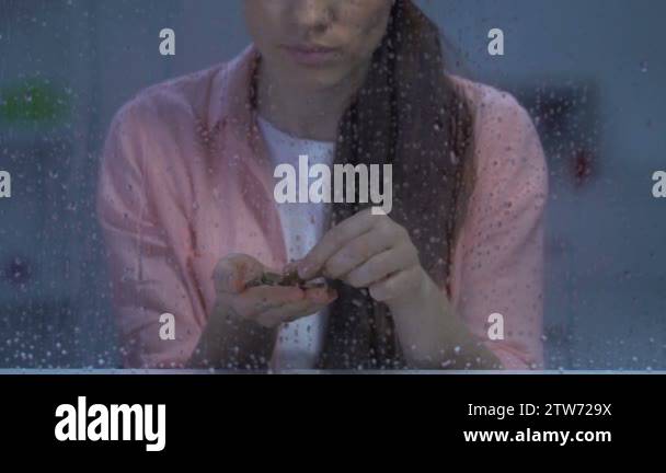 Poor middle aged female counting coins, suffering extreme poverty ...