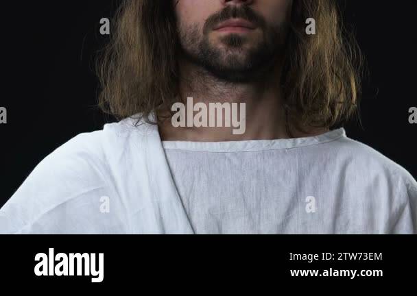 Jesus Christ in robe reaching out his hand to camera, saving sinner ...