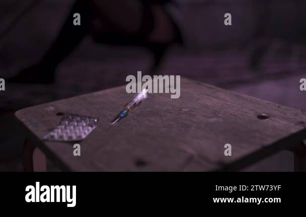 Filled Syringe and Pills on a table - Underground nightclub party ...