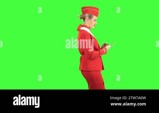 Woman steps with the phone and writes a message . Green screen. Side ...