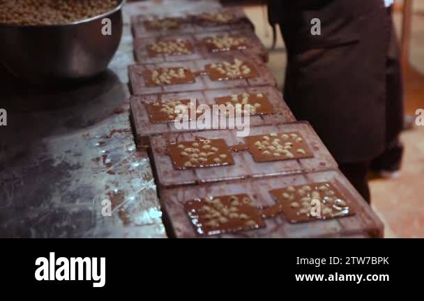 chocolate factory, the process of making chocolate. pouring liquid ...