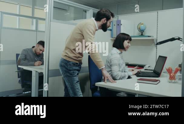 Manger in the office checking the work of his workers , make a ...