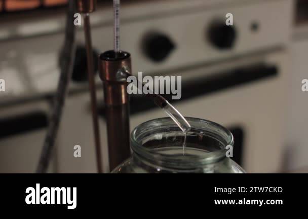 Home production of alcohol on flame fire. Alcohol distillation ...