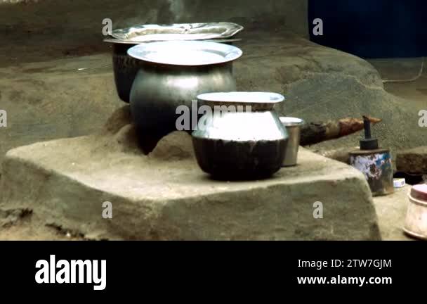 Traditional indian stone stove, Indian cooks food on a traditional ...