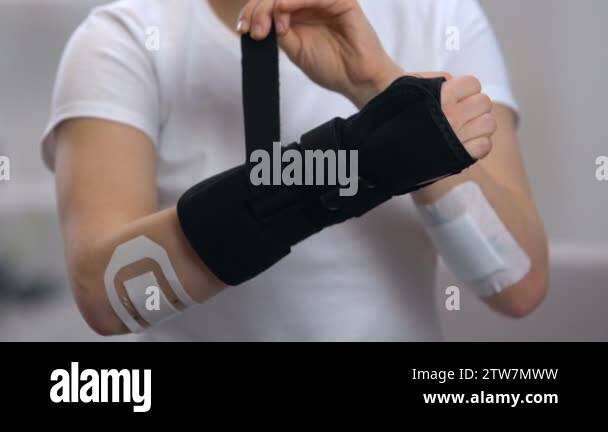 Woman wearing titan wrist brace, orthopedic support after trauma ...