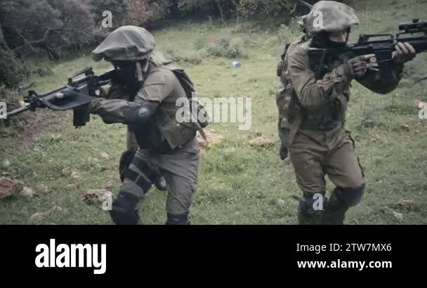 Squad of fully armed commando soldiers during combat in a forest ...