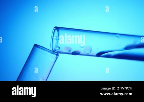 Clean fluid is poured from one tube into another in a medical ...