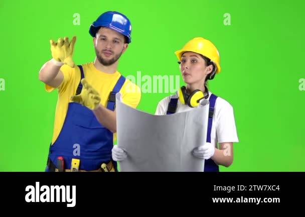 Two architects discuss the drawing of the new building. Green screen ...