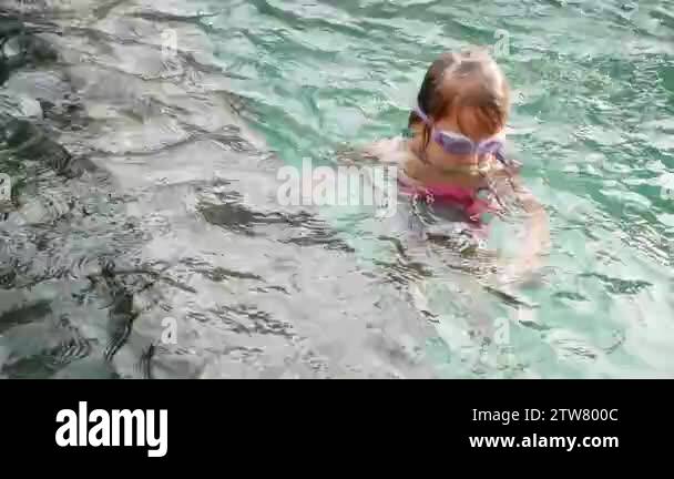 Little girl swim underwater in swimming pool. Slow Motion Stock Video ...