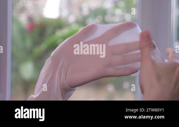 close-up. Female hands test the integrity of kapron stockings. a torn ...