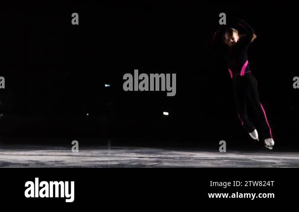A professional skater performs a skating jump with the rotation in the ...
