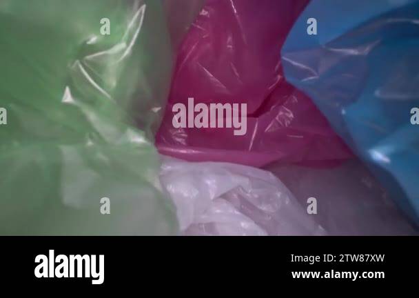 Dolly shot through disposable plastic bag background. Transparent, reusable plastic waste ...