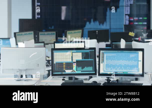 4K Interior of city financial trading room with screens showing charts ...