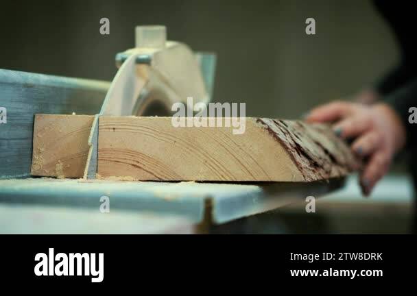 Cutting wood at a wood factory. Close up clips of sawing wood. A ...