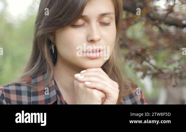 young woman moves lips saying the words of the prayer to God , girl ...
