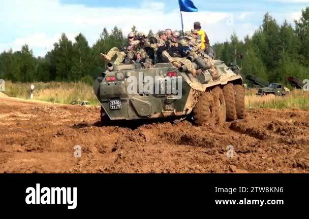 Squad of strikeball team with machine submachine guns on military tank ...