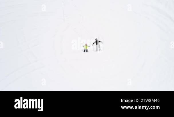Overhead aerial top view over mother and child daughter lying doing ...