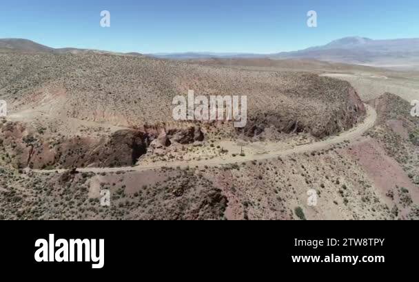 Aerial drone scene of train rail that crosses desertic mountain. Train ...