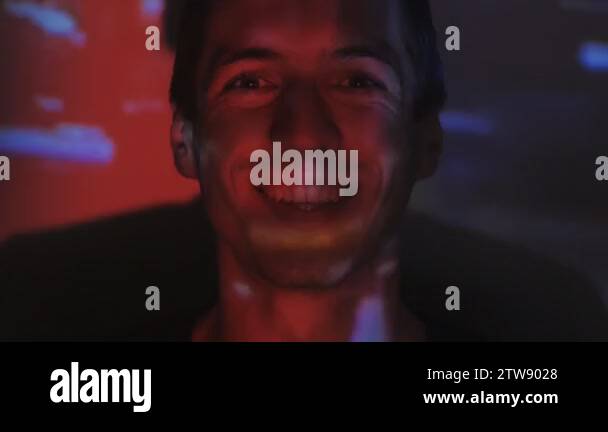 portrait of a young man watching a video or film on TV or a computer ...