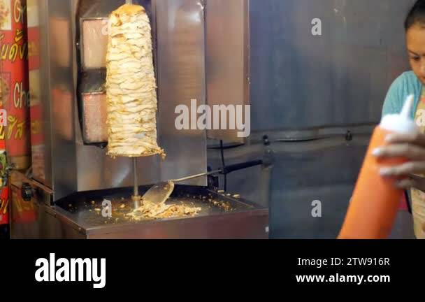 Asian Shawarma is prepared in the night food market of Jomtien Stock ...