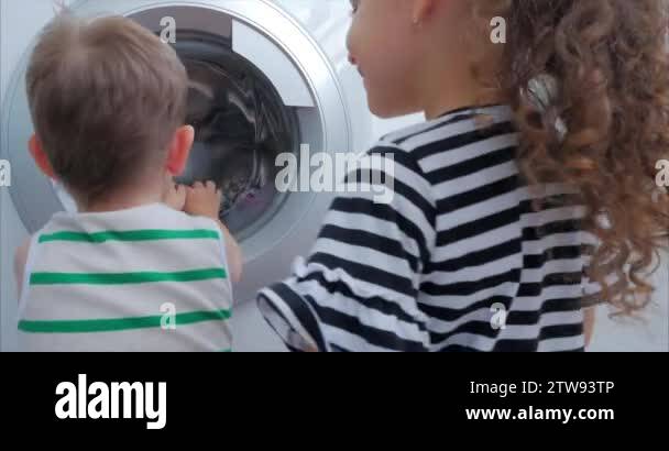 Cute Children Looks Inside the Washing Machine. Cylinder Spinning ...