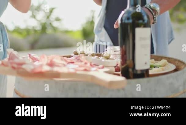 Romantic couple, man and woman toasting with red wine and eating finger ...