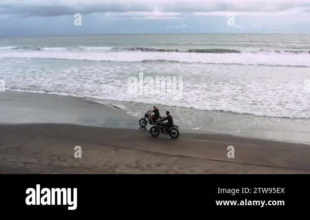 Two handsome hipster men riding modern custom motorcycle cafe racer on ...